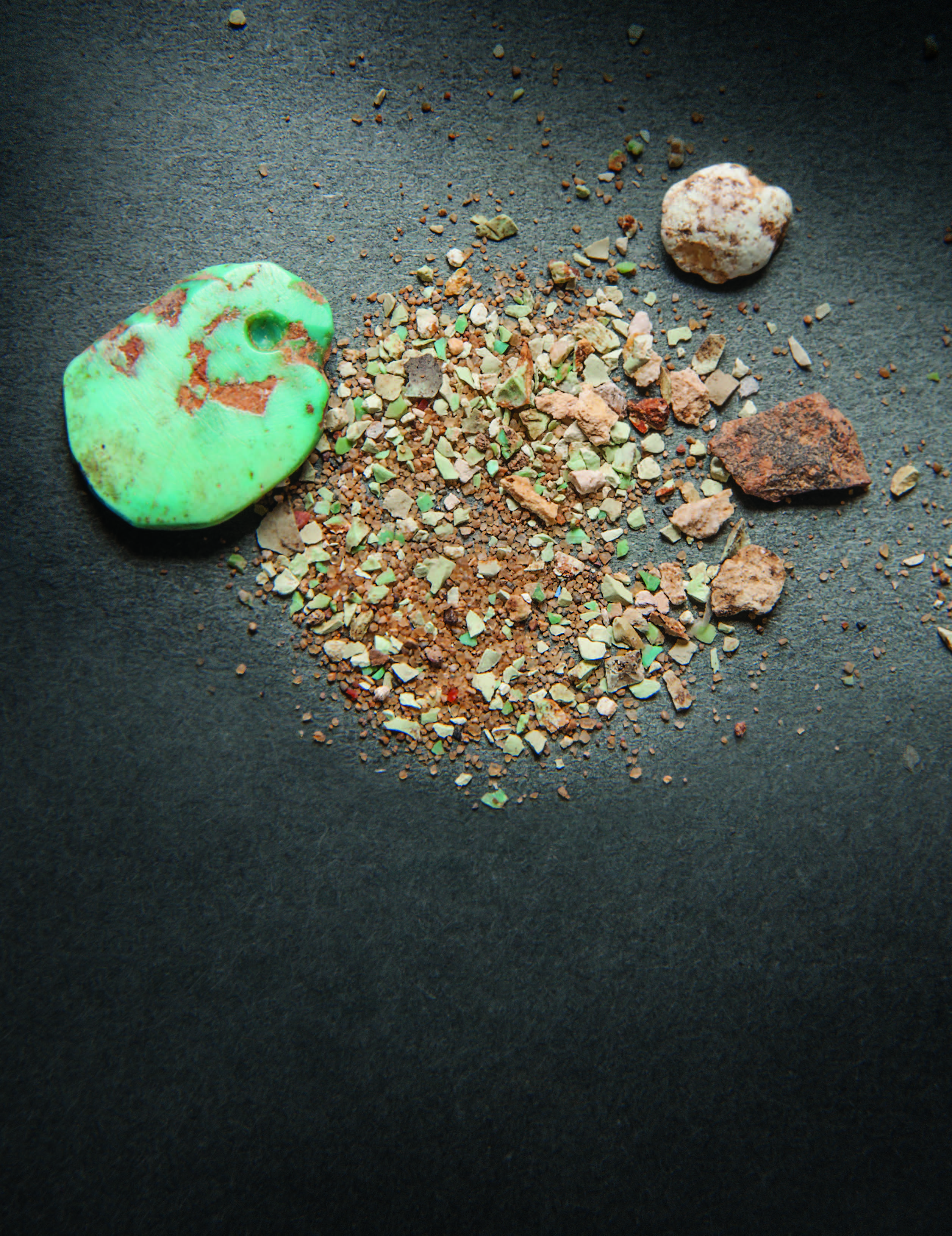 A partially drilled pendant, and scraps of lithic material from the ...